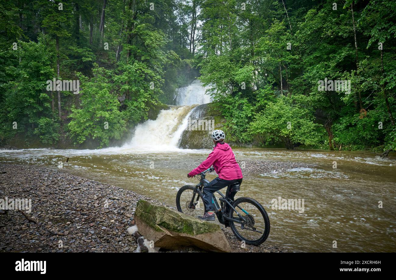 senior woman, riding her electric mountain bike and watching the Eibele ...