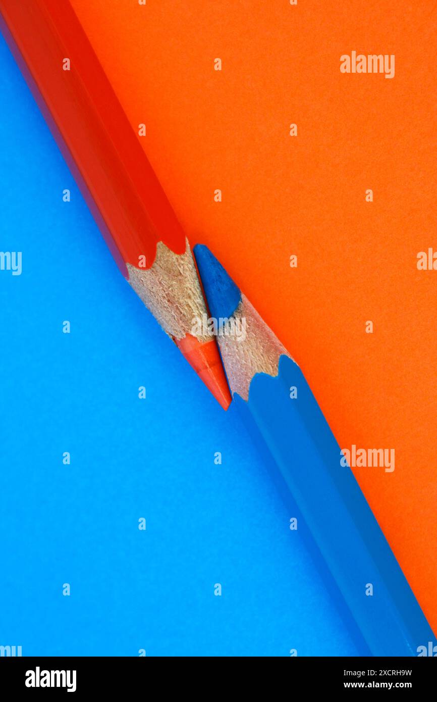Blue and orange contrasting pencils Stock Photo - Alamy