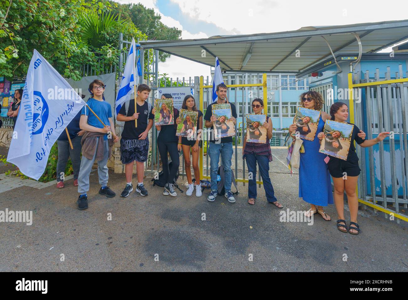 Haifa, Israel - June 17, 2024: People stand outside of high school gate ...