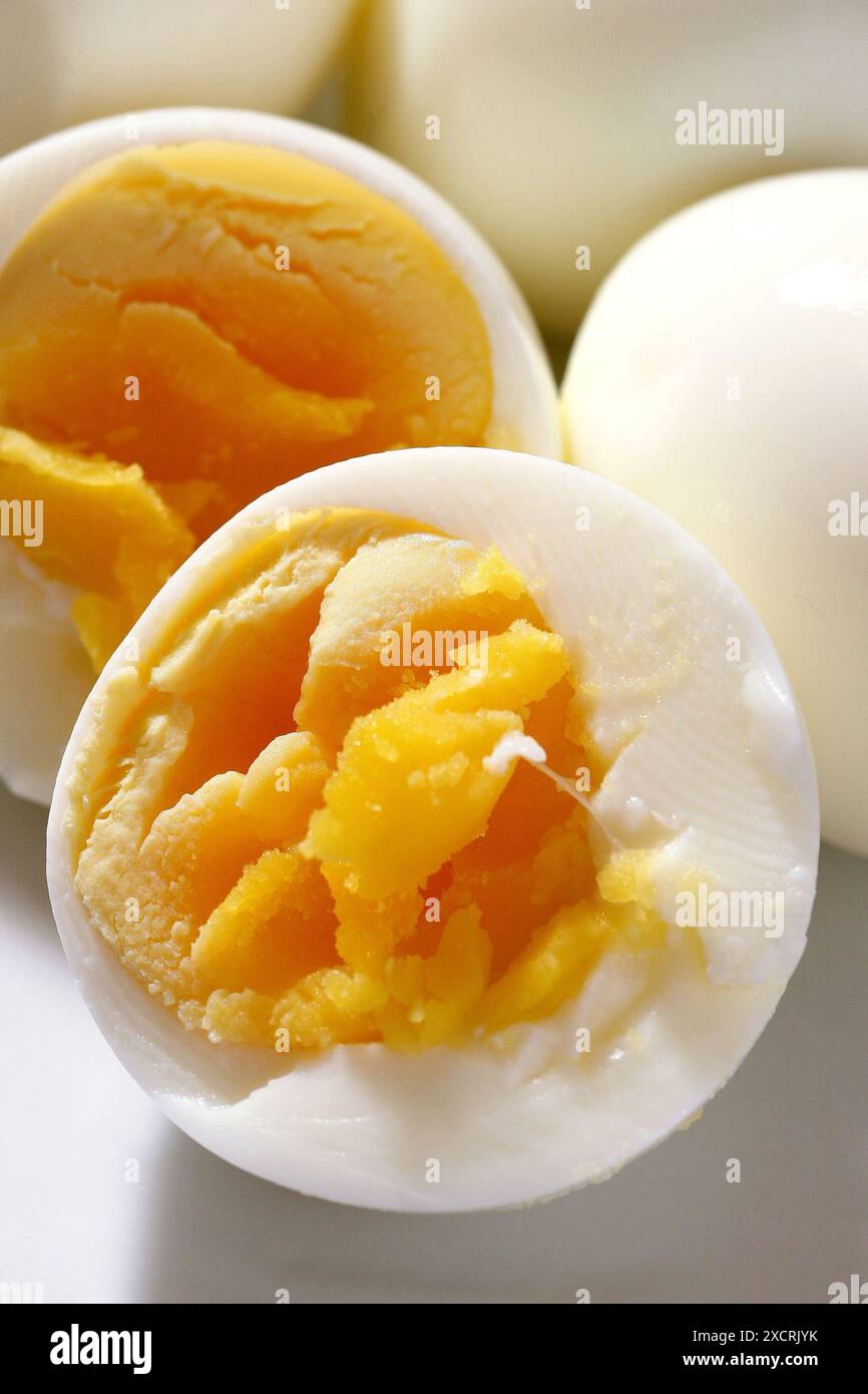 The cross-section of the boiled egg showing a golden yellow yolk Stock ...