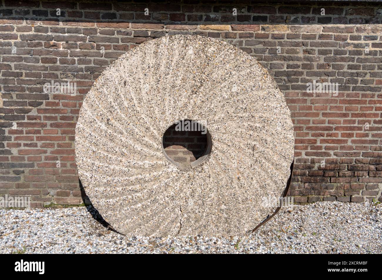A textured mill stone, used for grinding flour from wheat in the ...