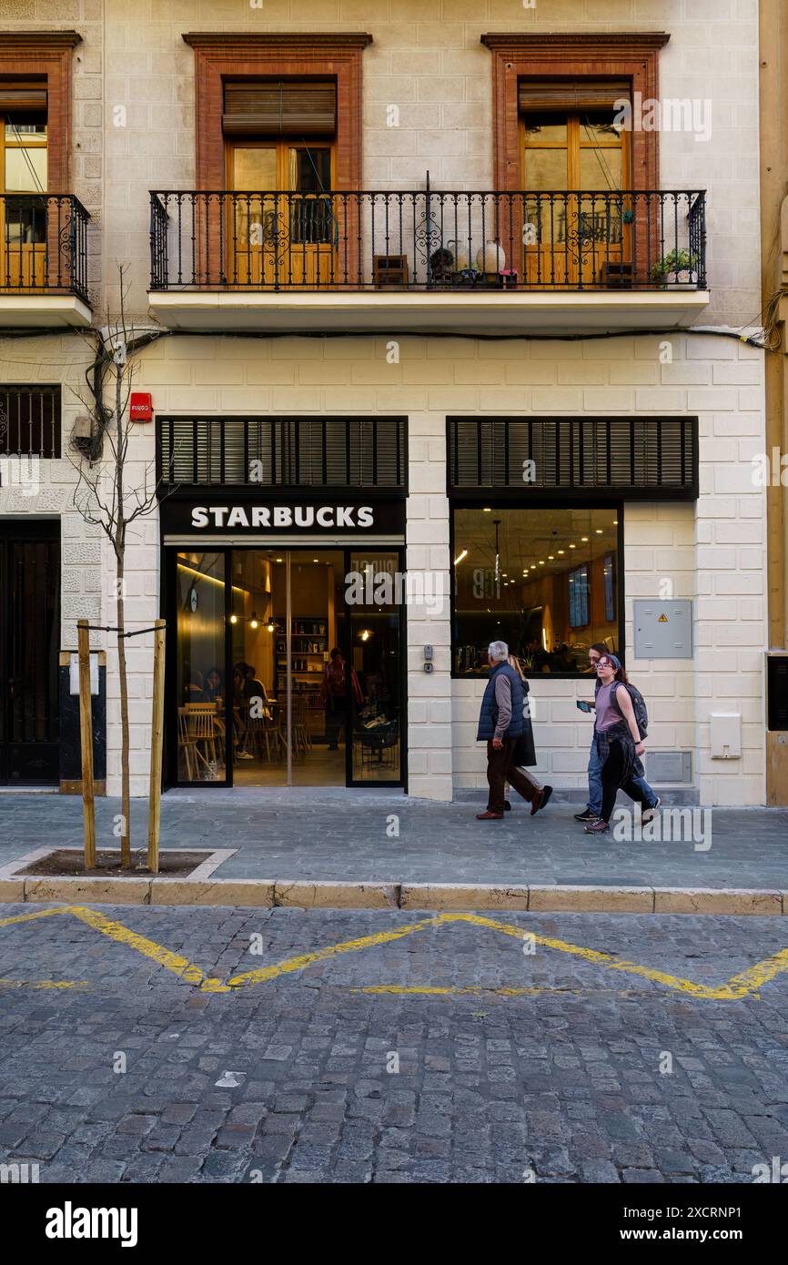 Seville, Spain. February 4, 2024 People walking past a starbucks coffee ...