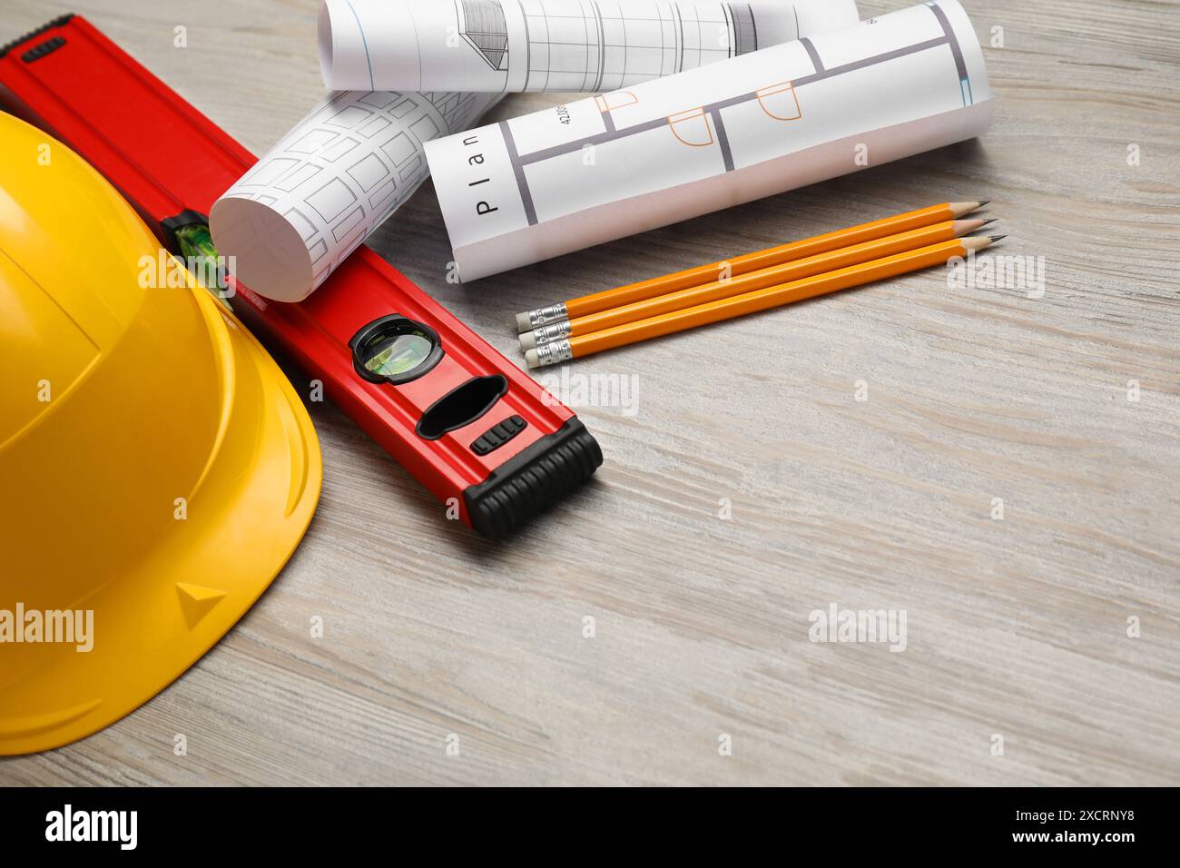 Building level and other construction tools on white wooden table ...