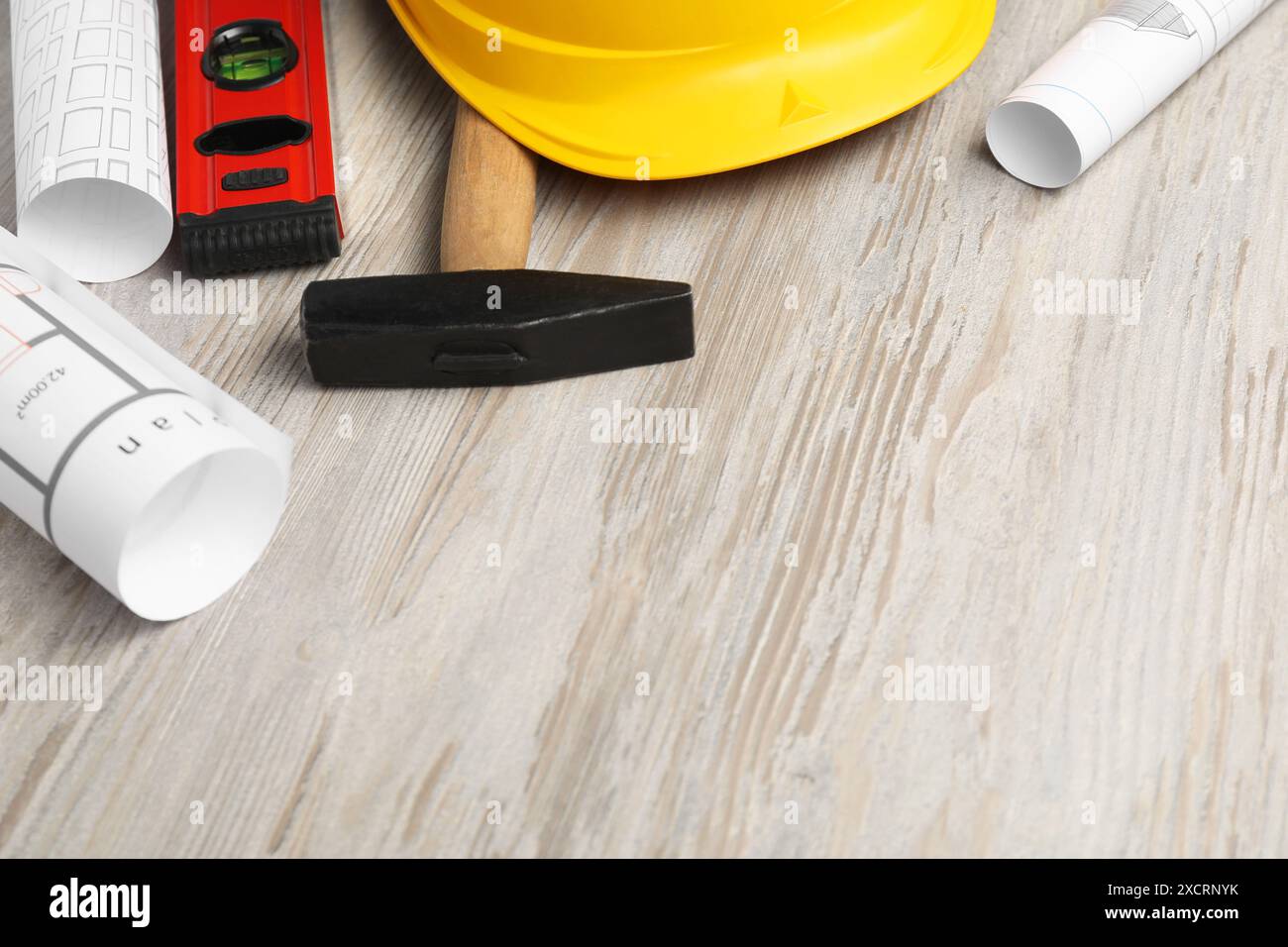 Building level and other construction tools on white wooden table ...