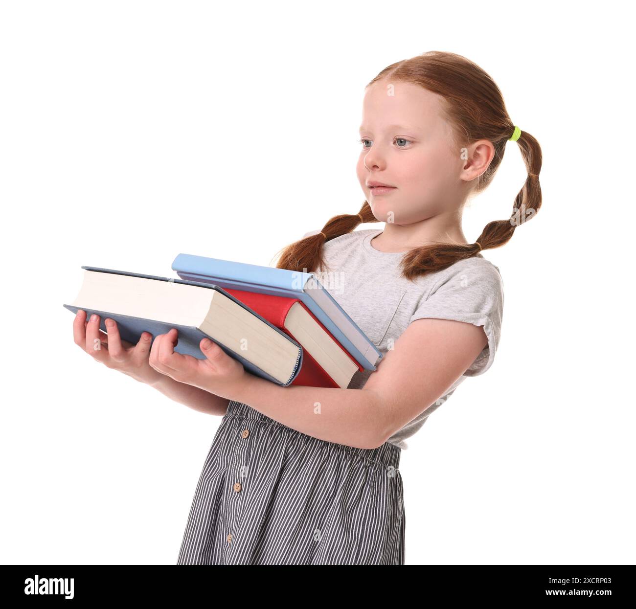 Cute little girl with stack of books on white background Stock Photo ...
