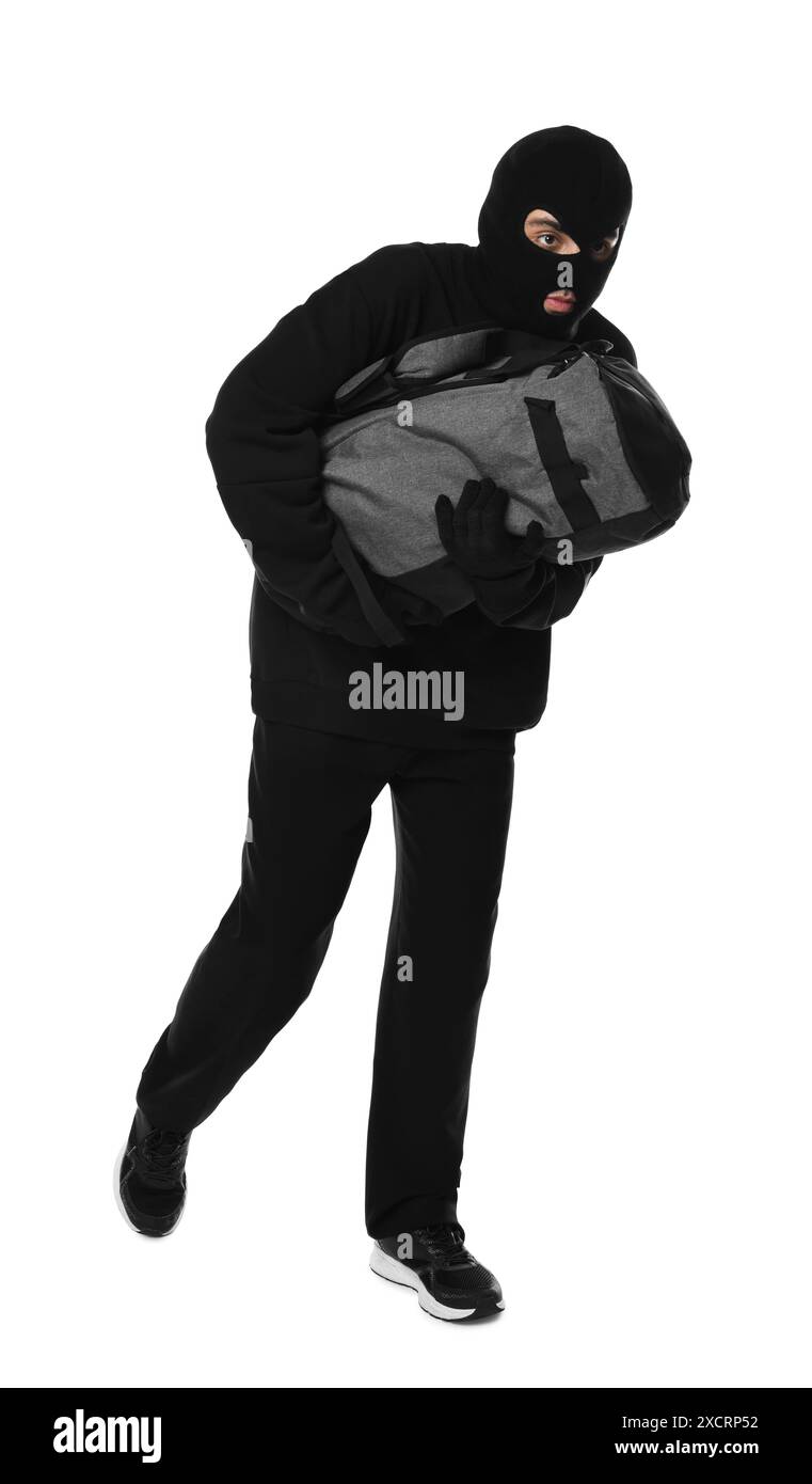 Thief in balaclava running with bag on white background Stock Photo - Alamy