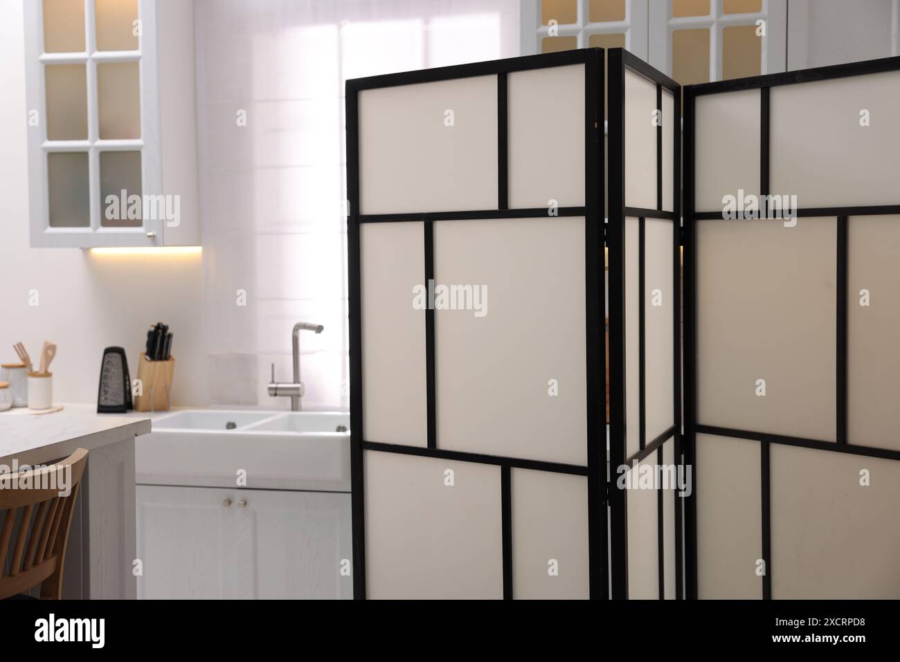 Stylish kitchen interior with folding screen and countertop Stock Photo ...