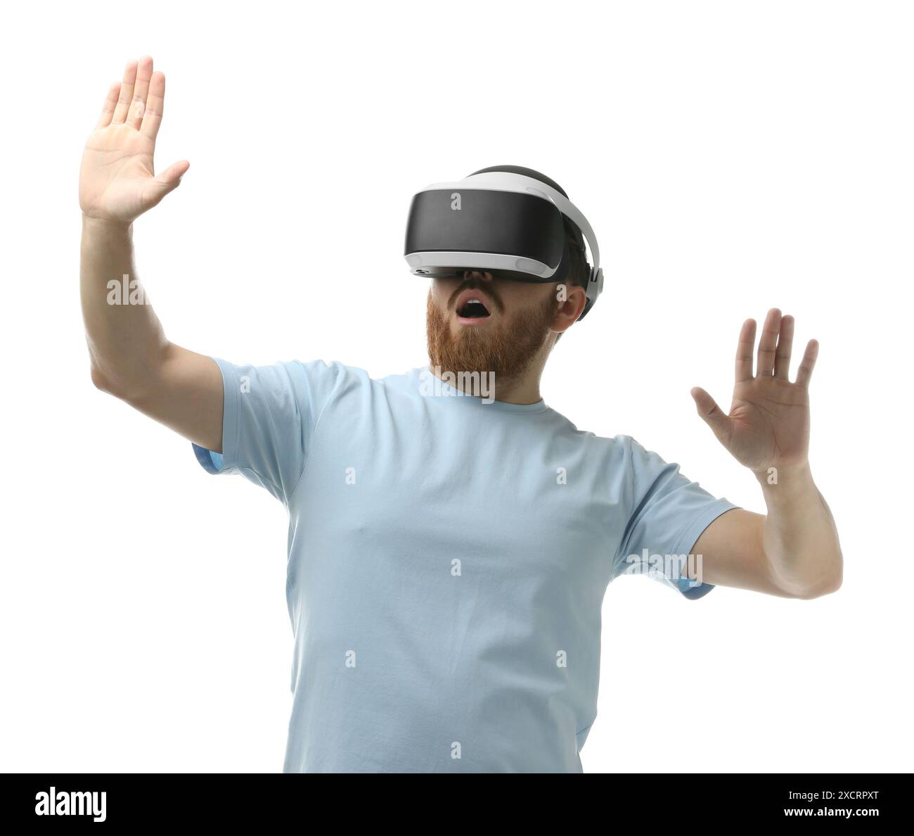 Emotional man using virtual reality headset on white background Stock ...