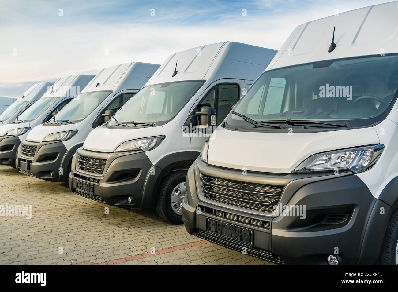Commercial delivery vans parking in a row, transporting and shipping ...