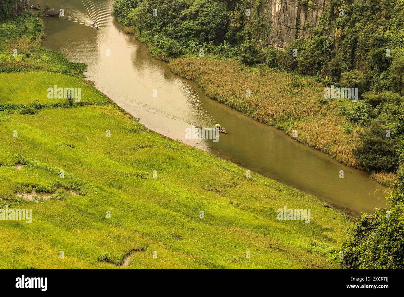 Breathtaking view of tourist sampans meandering along the Tam Coc river, taken from the ...