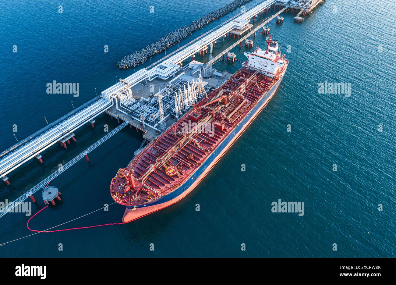 Aerial view of a large oil tanker docked at a pier in the port in ...