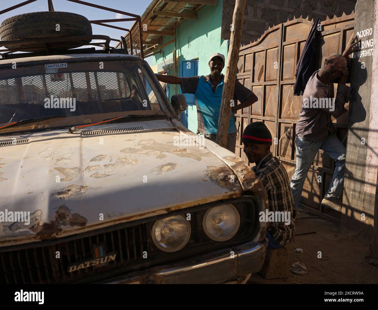 Car being repaired at a workshop by mechanics near Nanyuki Kenya Africa ...