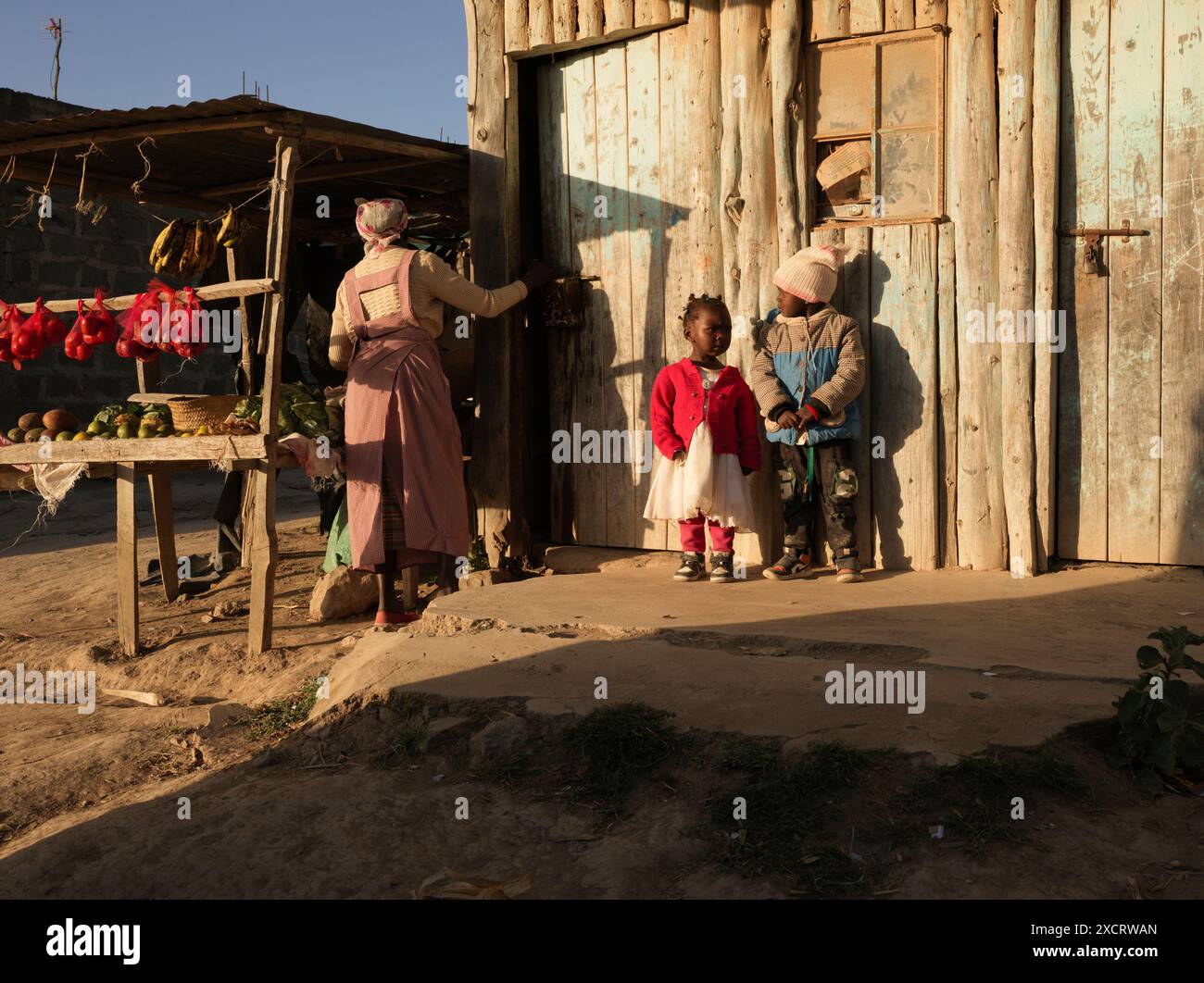 A grandmother looking after her vegetable shop and her grandchildren ...