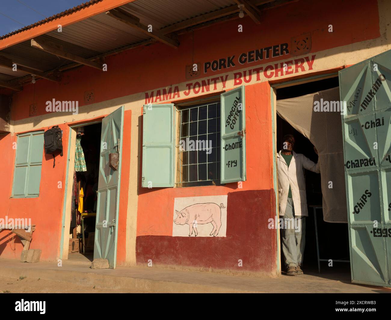Butcher standing in the doorway of his pork butchery near Nanyuki Kenya ...