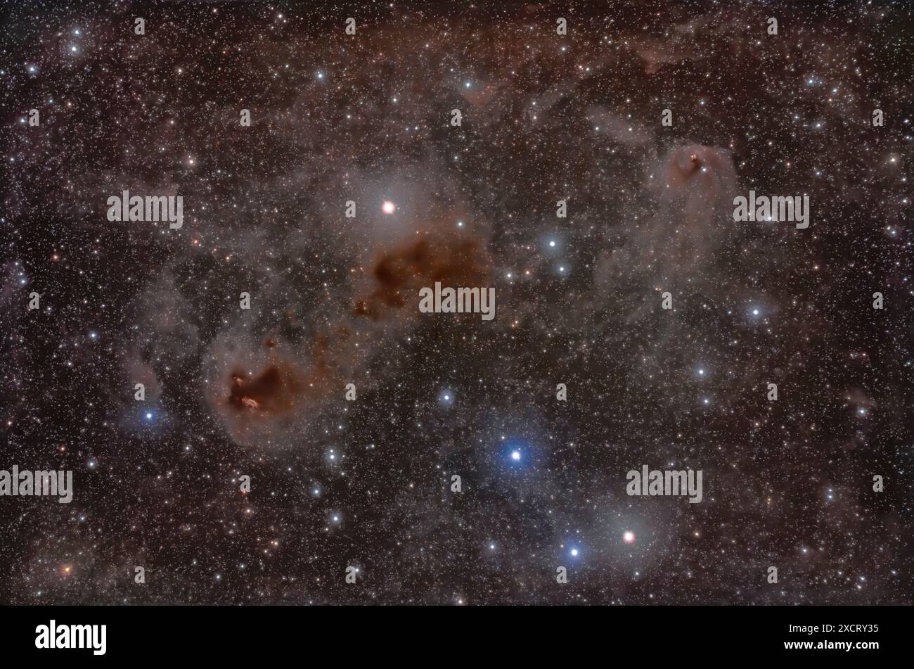 This is a framing of dust clouds among the stars of the Hyades star ...