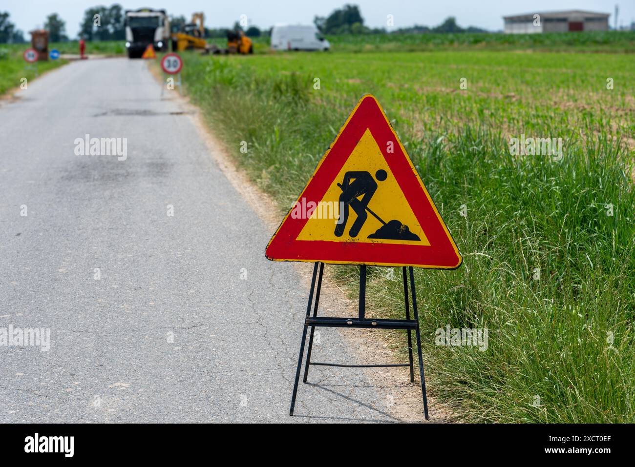 Road sign indicates work in progress on the italian road, visible ...