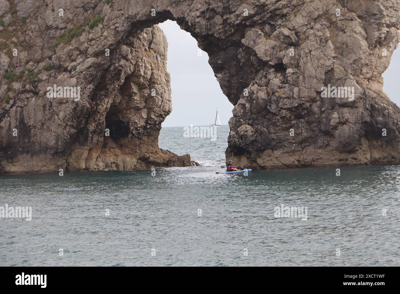 Boat sailing through a cove Stock Photo - Alamy