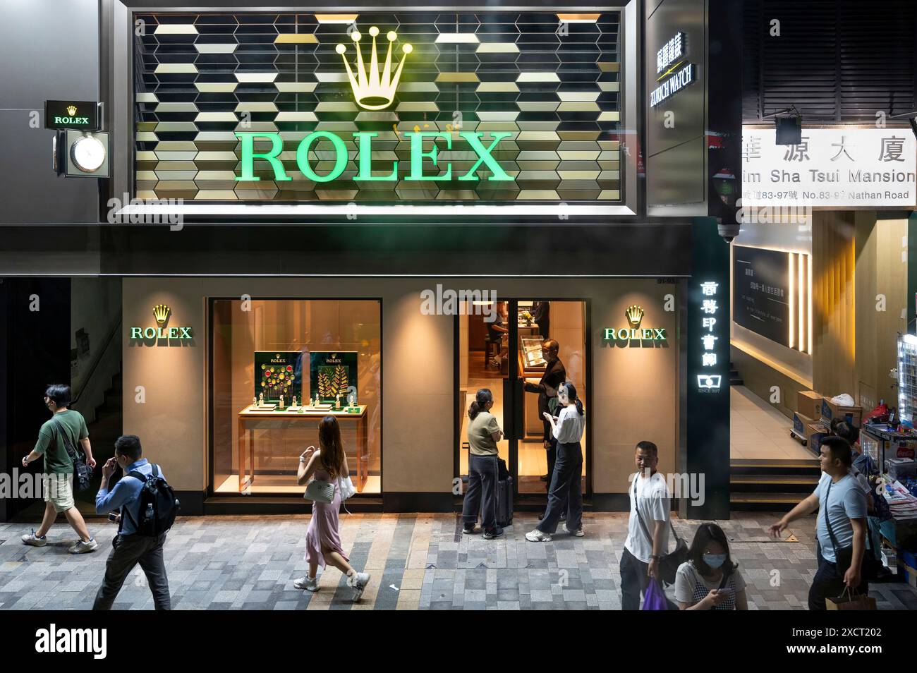 Hong Kong, China. 29th Apr, 2024. Pedestrians walk past the Swiss luxury watchmaker Rolex branch ...
