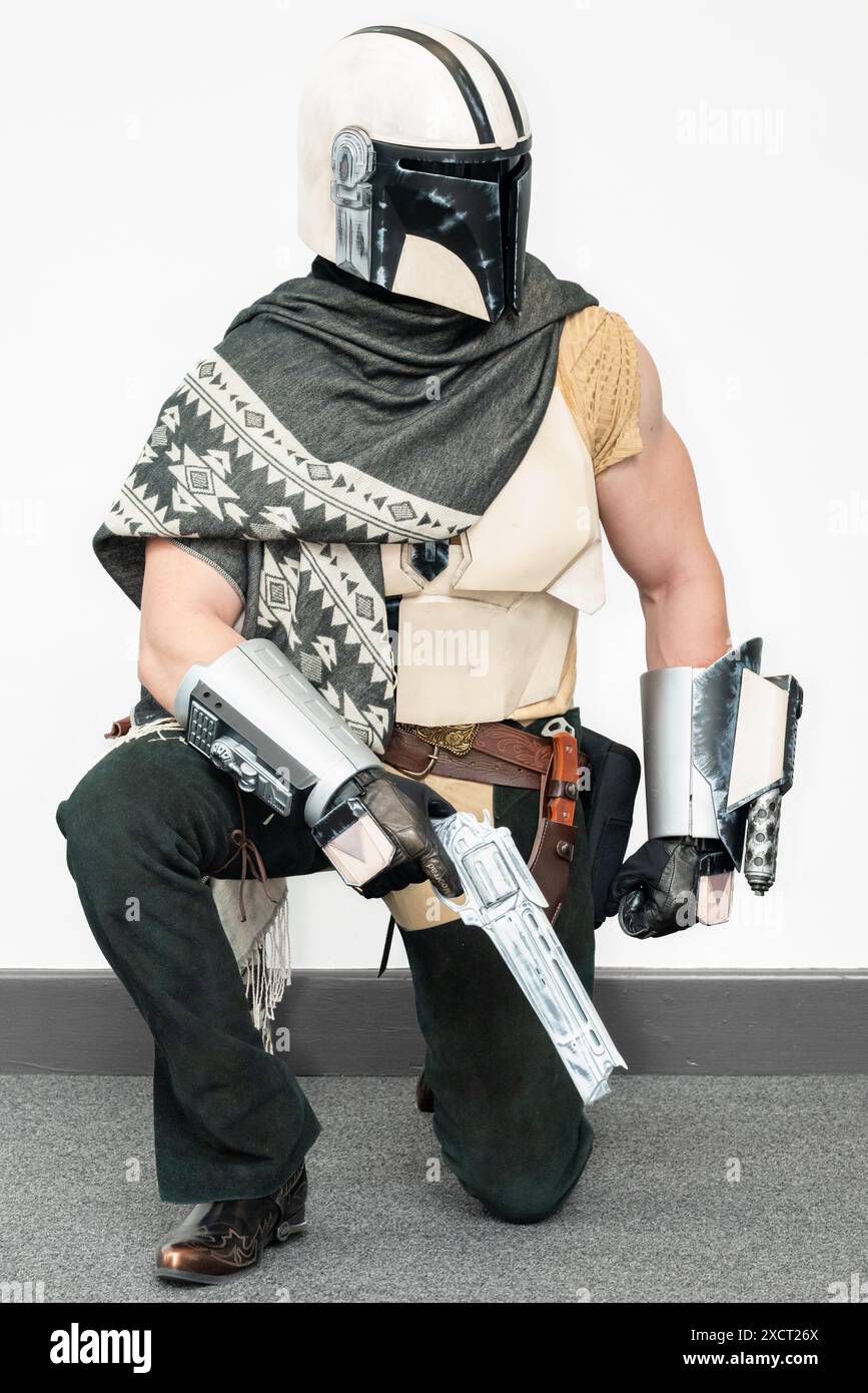 A male cosplayer dressed as a Star Wars character Mandalorian at Comic ...