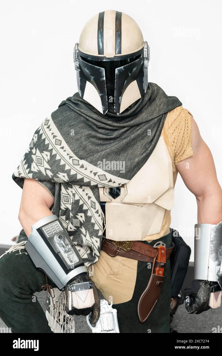 A male cosplayer dressed as a Star Wars character Mandalorian at Comic ...