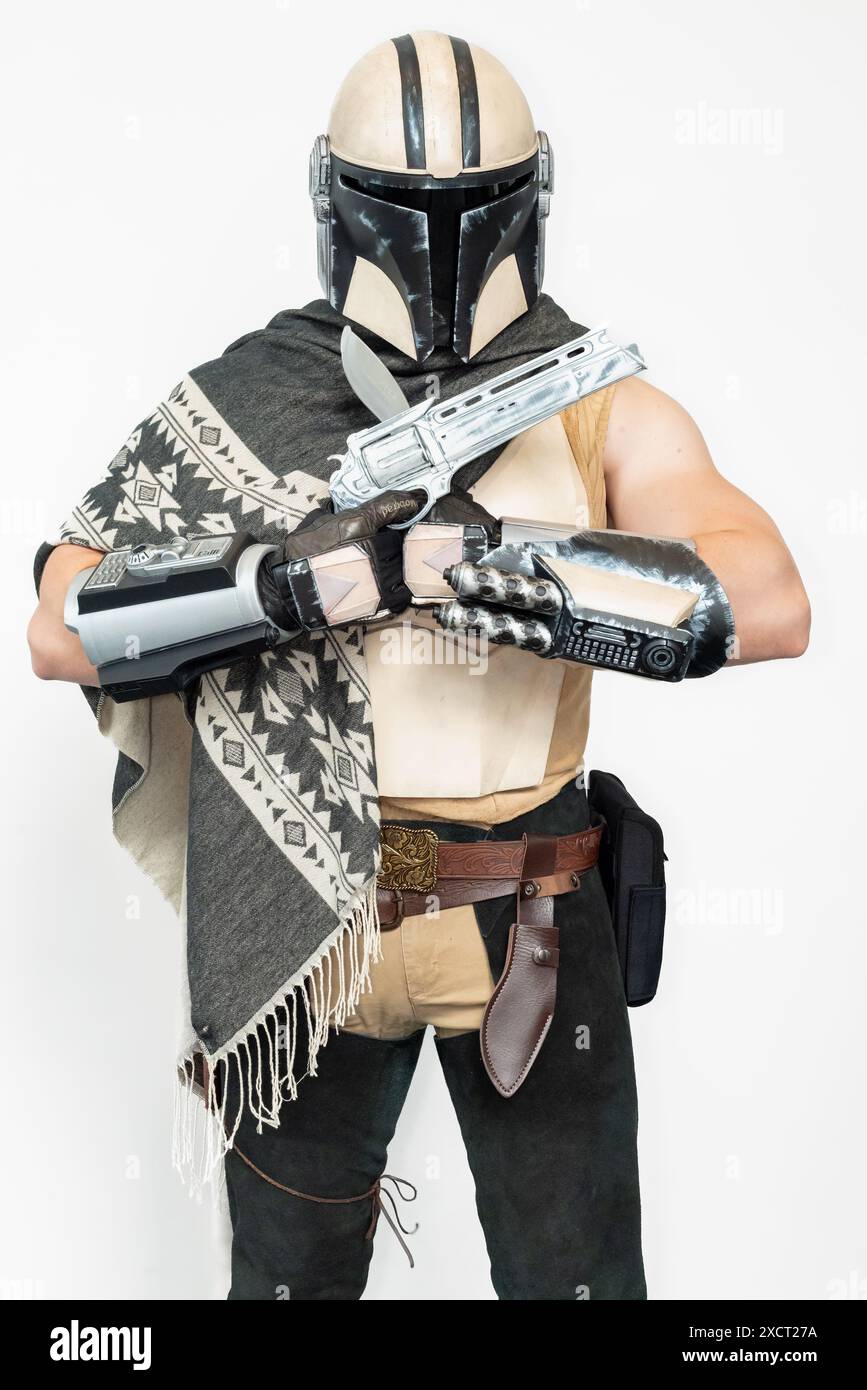 A male cosplayer dressed as a Star Wars character Mandalorian at Comic ...