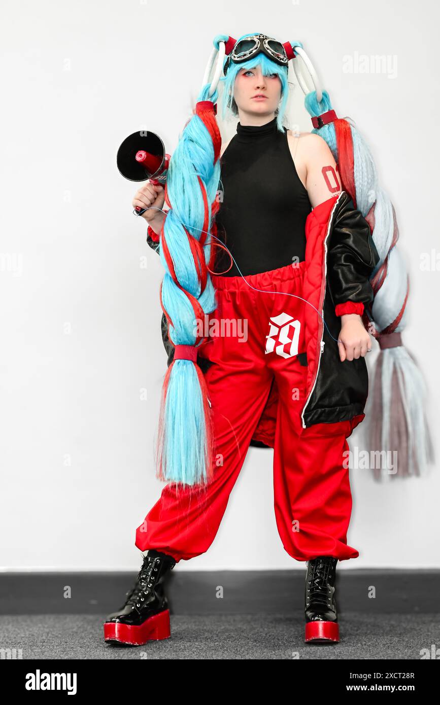 A female cosplayer dressed as an anime character with blue hair and a ...