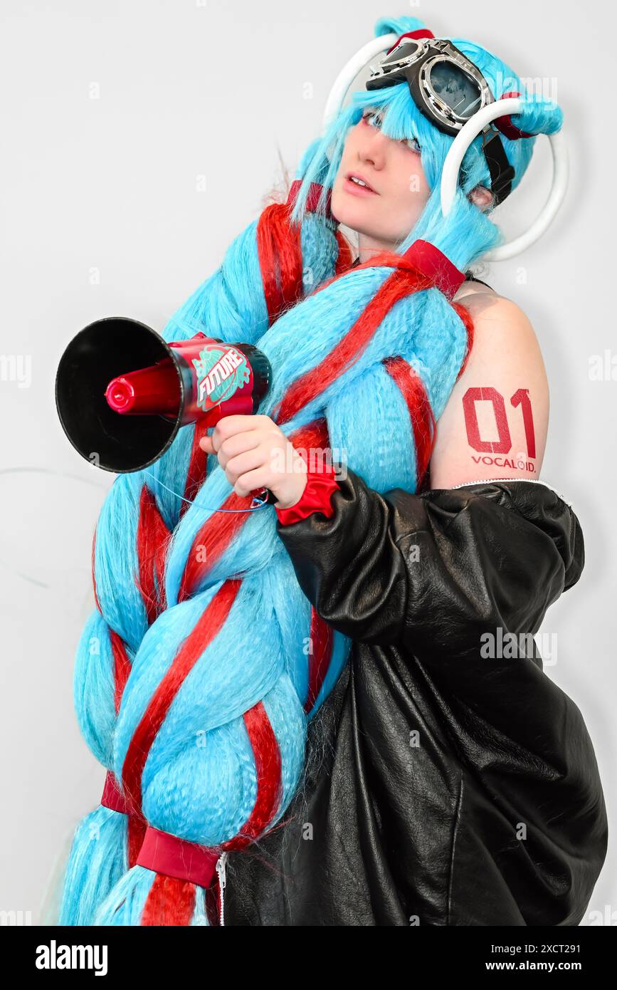A female cosplayer dressed as an anime character with blue hair and a ...