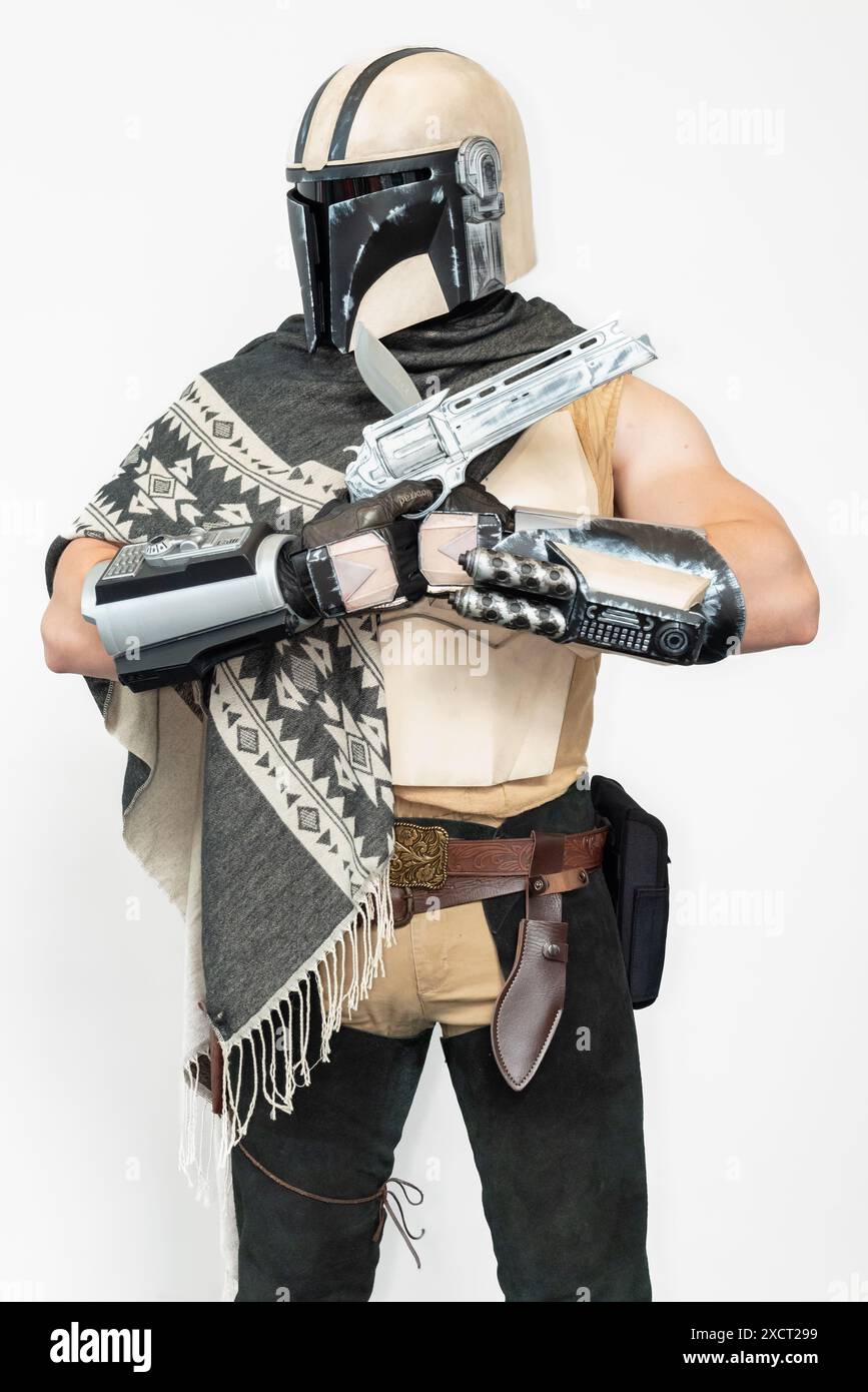 A male cosplayer dressed as a Star Wars character Mandalorian at Comic ...