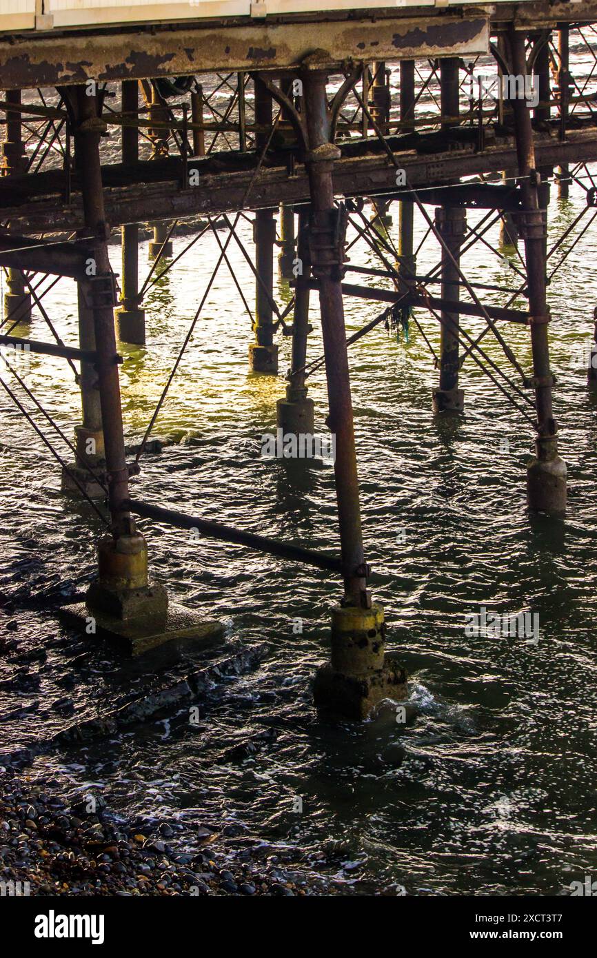 Sunlight colouring the water golden below the old Victorian Pier at ...