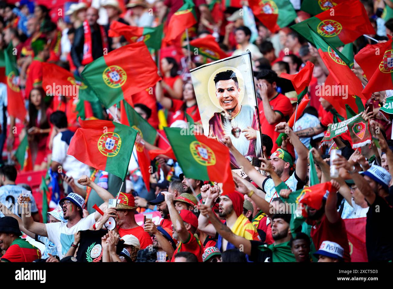 A Portugal fan holds up a banner with an image of Cristiano Ronaldo ...