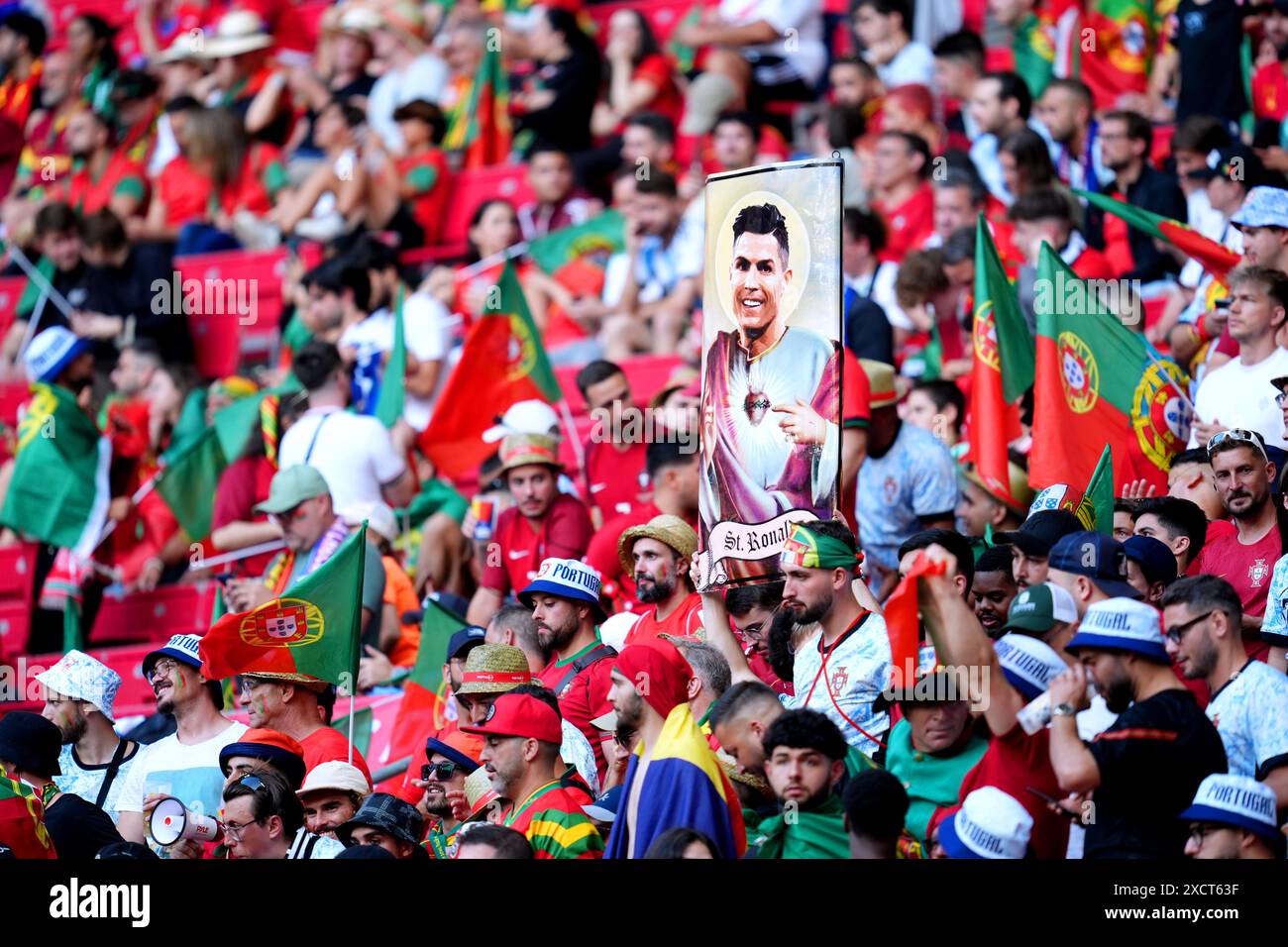 A Portugal fan holds up a banner with an image of Cristiano Ronaldo ...
