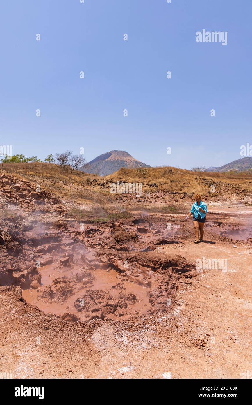 San Jacinto , Nicargaua - March 16, 2024: Woman collecting hot mud form ...