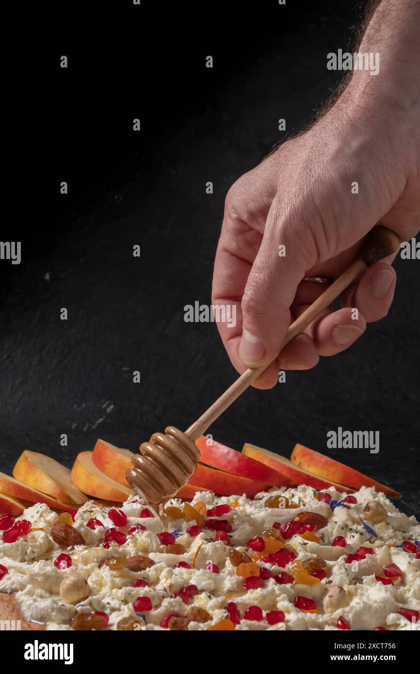 Trendy sweet butter board. Cooking process. man's hand sprinkle with ...