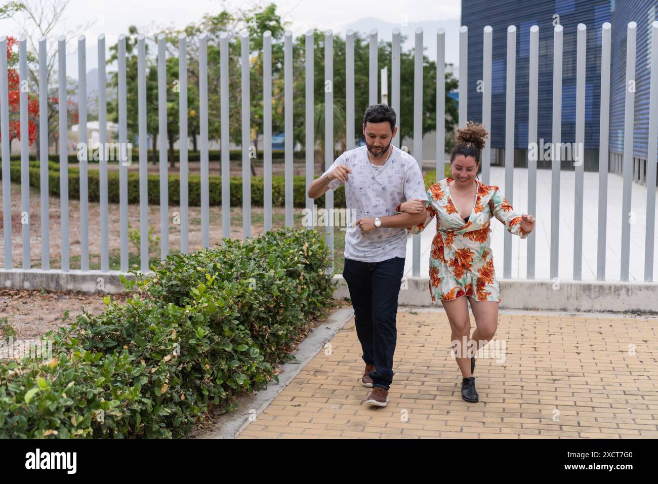 Playful couple walking together outdoors in an urban setting Stock ...