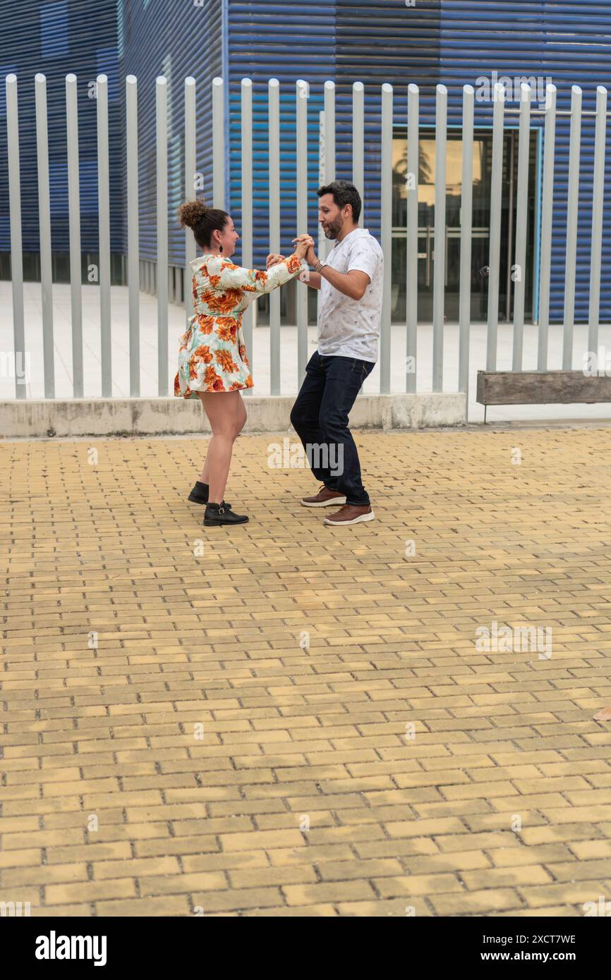 Couple Dancing Outdoors in Urban Setting Stock Photo - Alamy