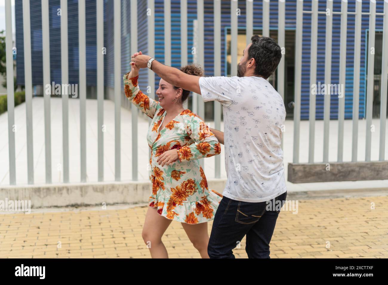 Couple Dancing Joyfully in Urban Environment Stock Photo - Alamy