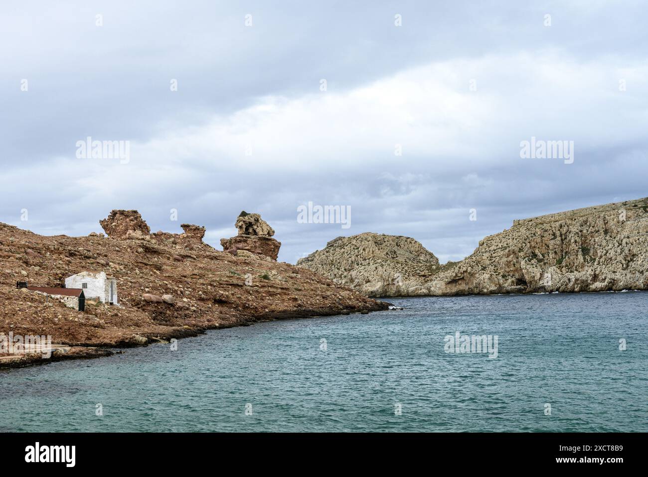 The distinctive rocky formations of Cala Morell, Menorca, under an ...