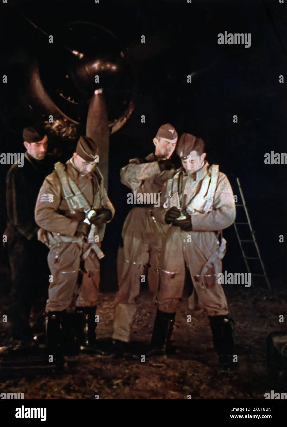 A photograph shows Luftwaffe personnel preparing an aircraft for a ...