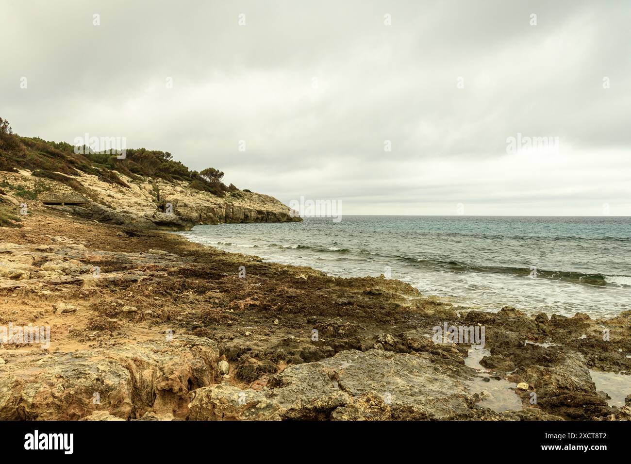Dramatic view of Santo Tomas Beach in Menorca, featuring a pebble ...