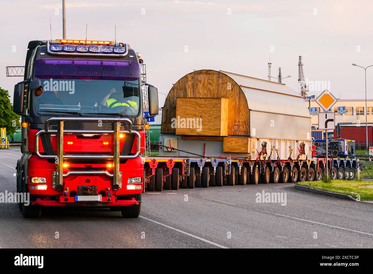The truck with a very long multi-axle multi-tire semi-trailer carries a ...