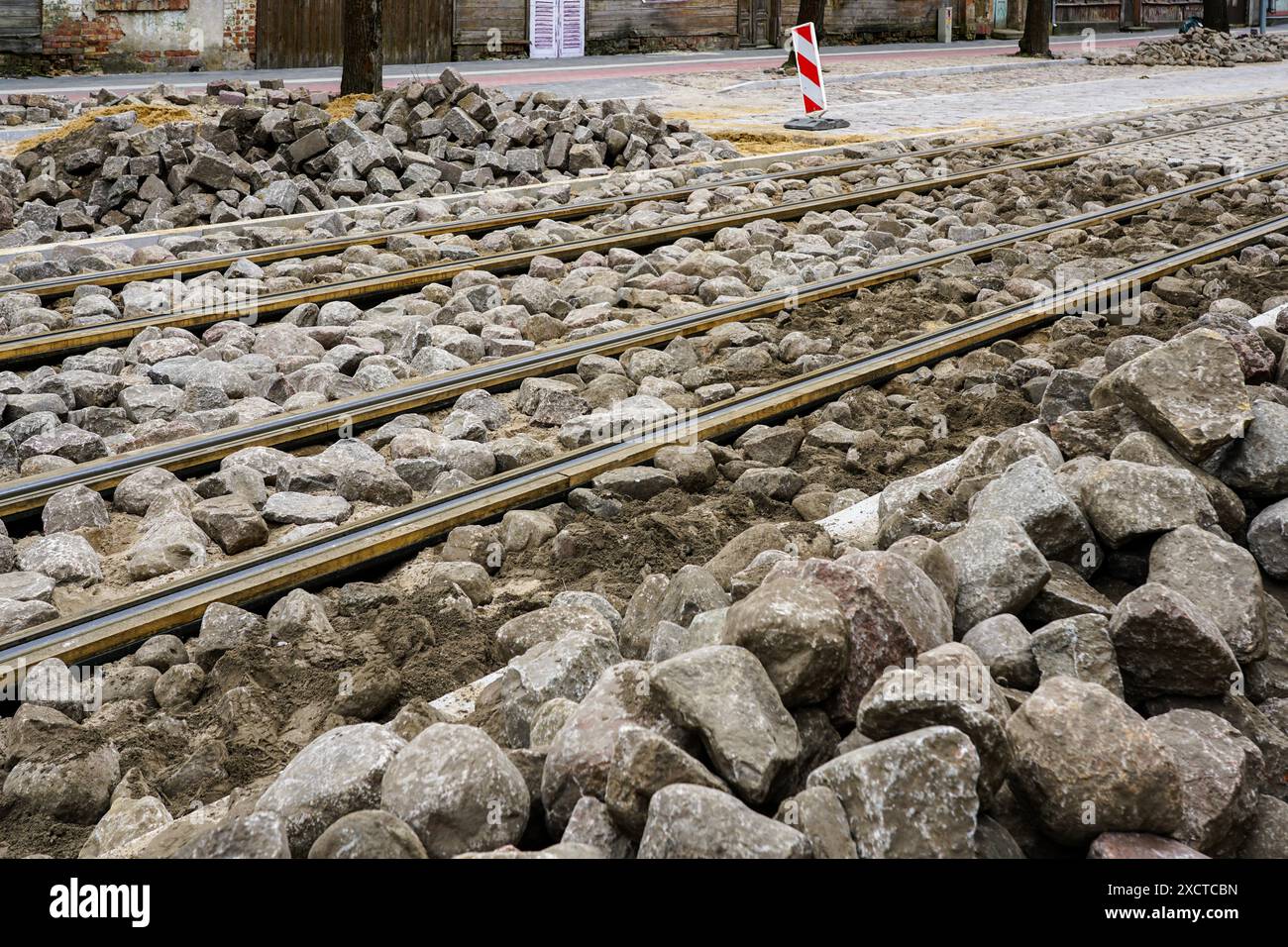 Paving of the tram tracks and street with historic natural granite ...
