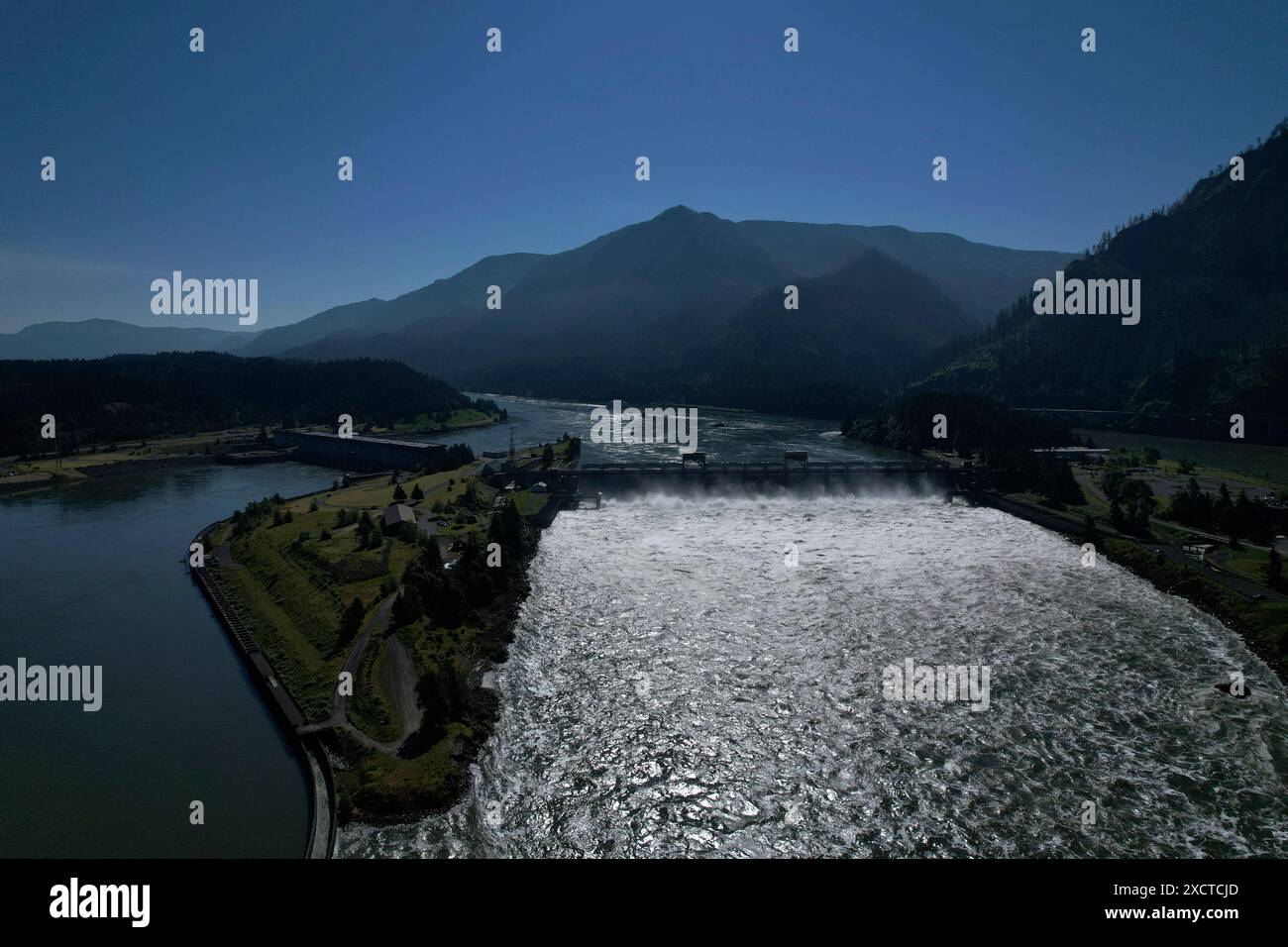 FILE - Water spills over the Bonneville Dam on the Columbia River ...