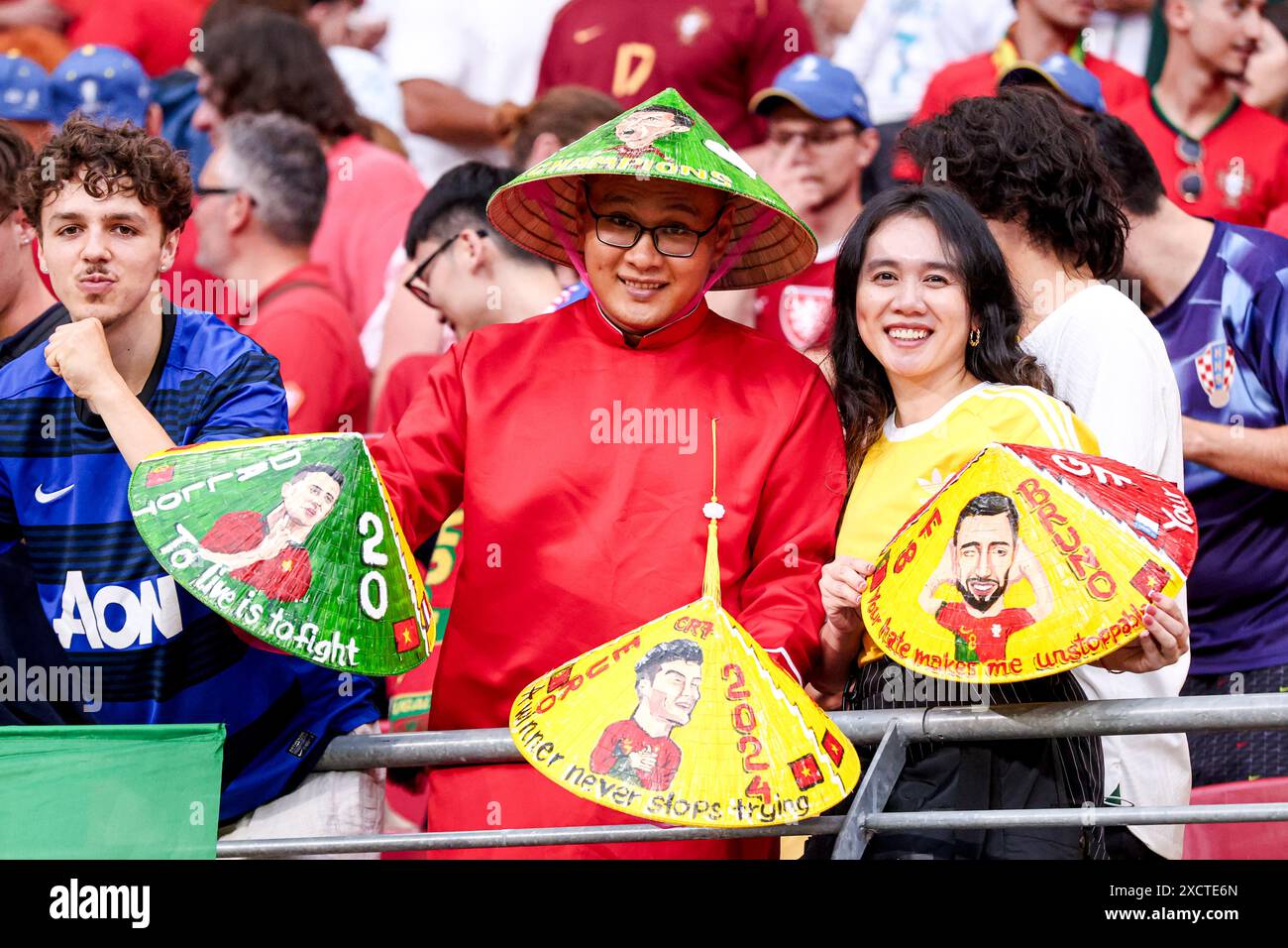 LEIPZIG, GERMANY - JUNE 18: Fans of Portugal with asian looking ...