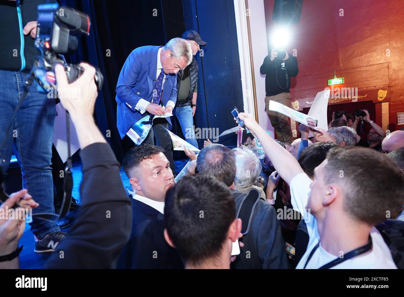 Reform UK leader Nigel Farage signing posters after speaking at Princes ...