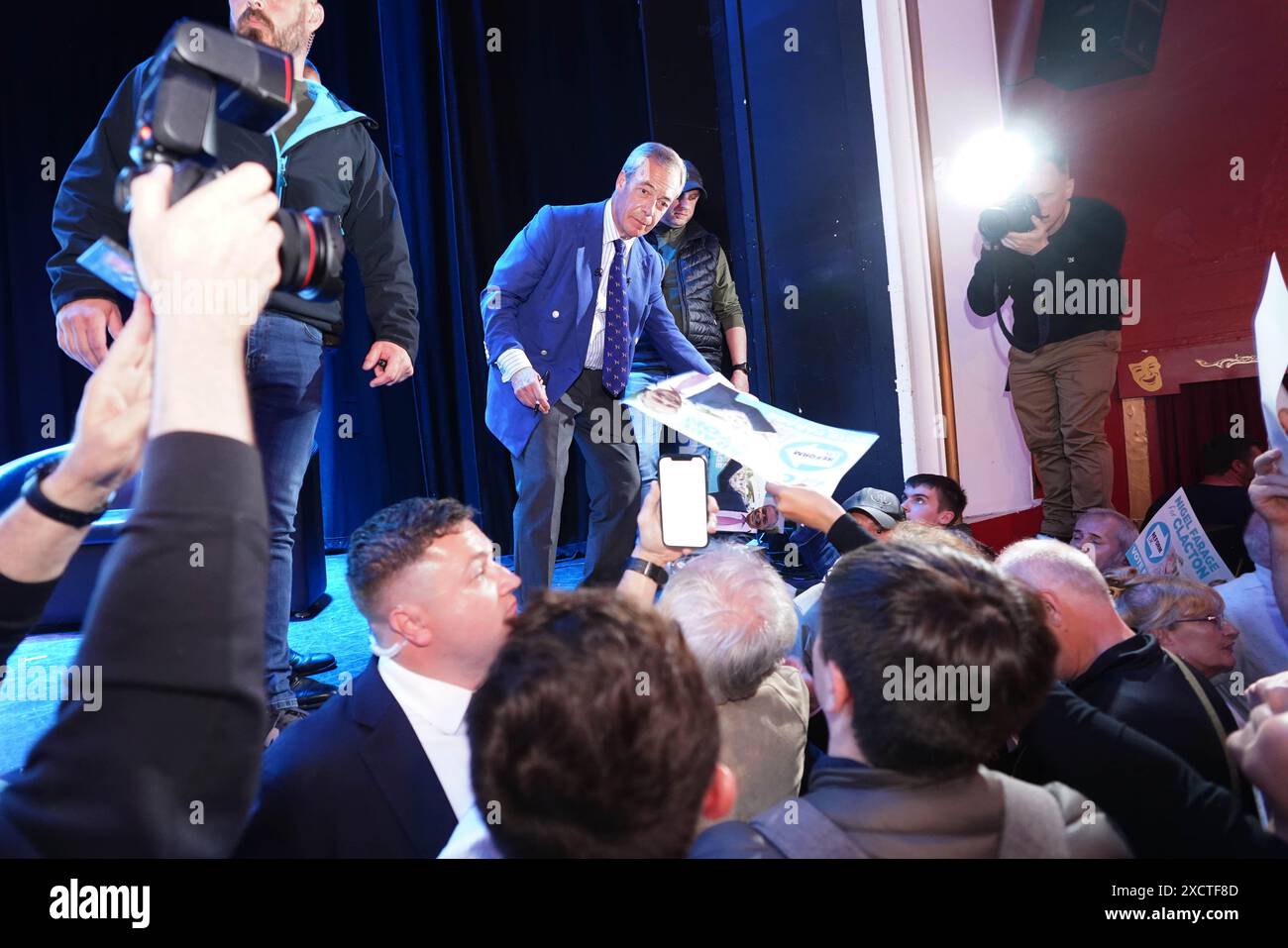 Reform UK leader Nigel Farage signing posters after speaking at Princes ...