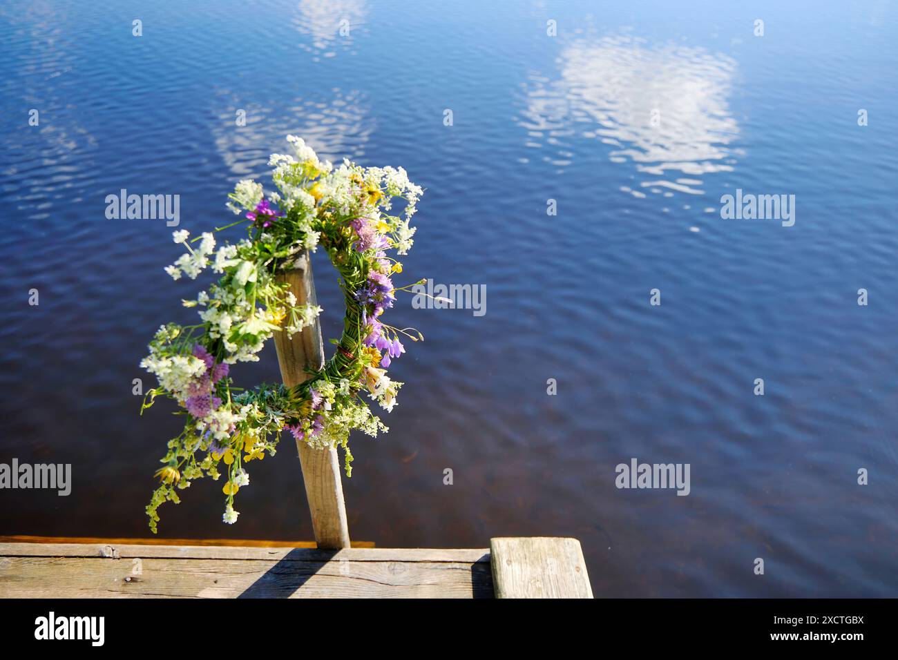 Midsummer background. Floral Wreath by the Water Stock Photo - Alamy