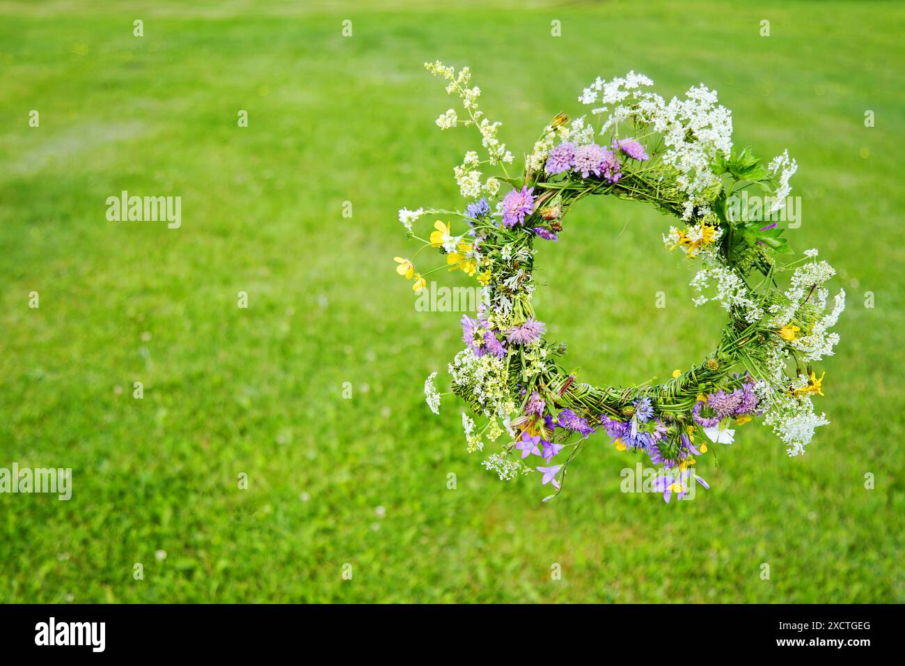 Midsummer background. Floral Wreath on Grass Stock Photo - Alamy