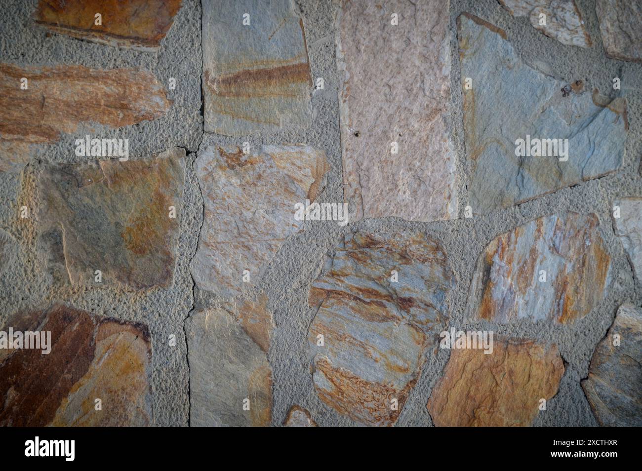 Stone wall texture background - grey stone siding with different sized ...