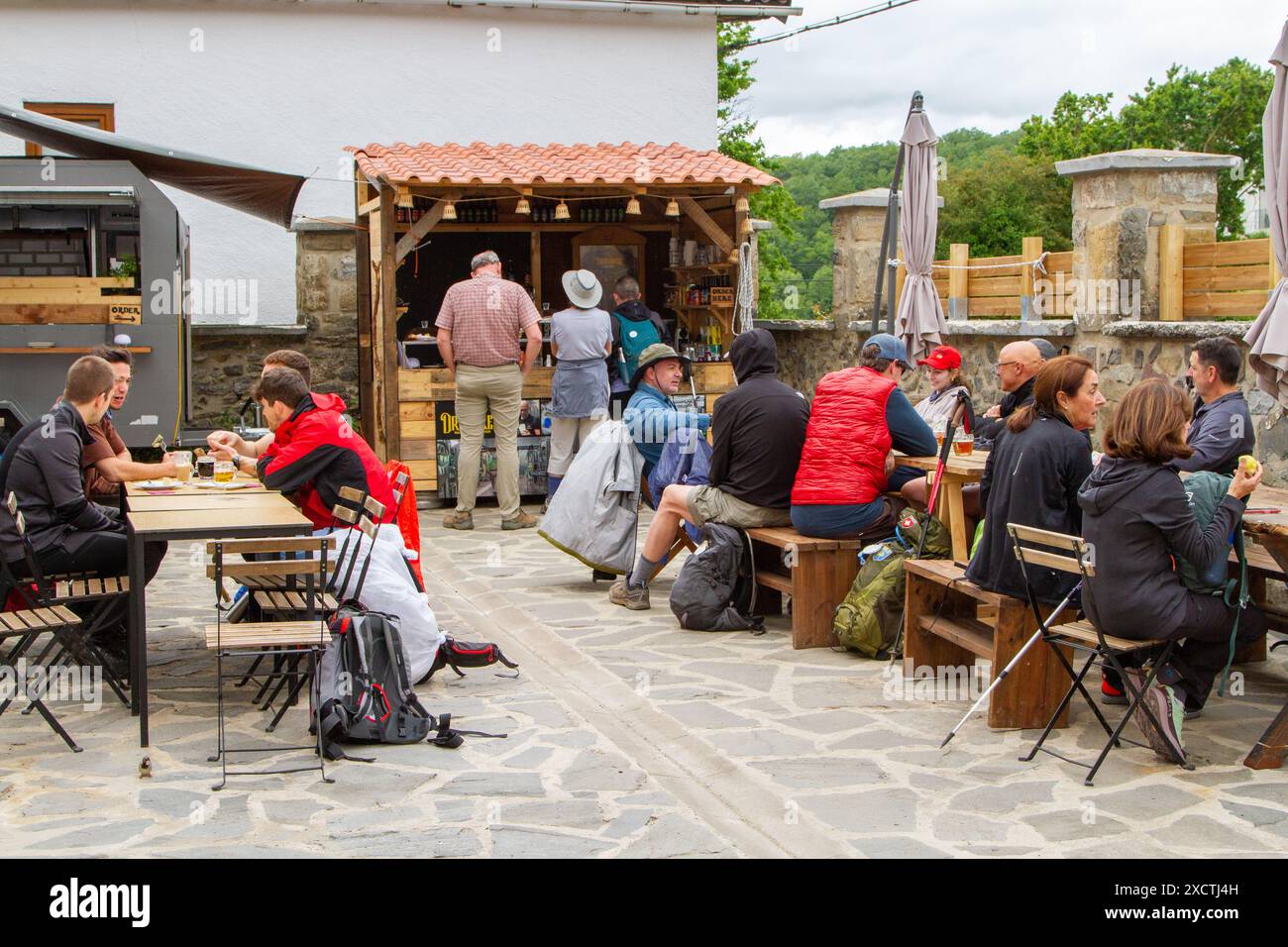 Pilgrims resting at a cafe bar in the Spanish village of Viskarret ...