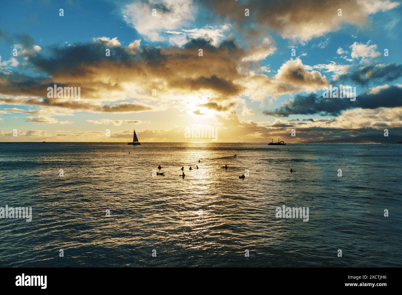 A group of people are enjoying a sunset swim in the ocean together ...